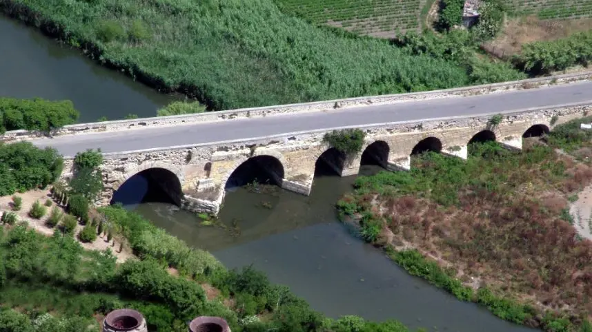 An illuminated pedestrian path in the Roman Bridge of Turris